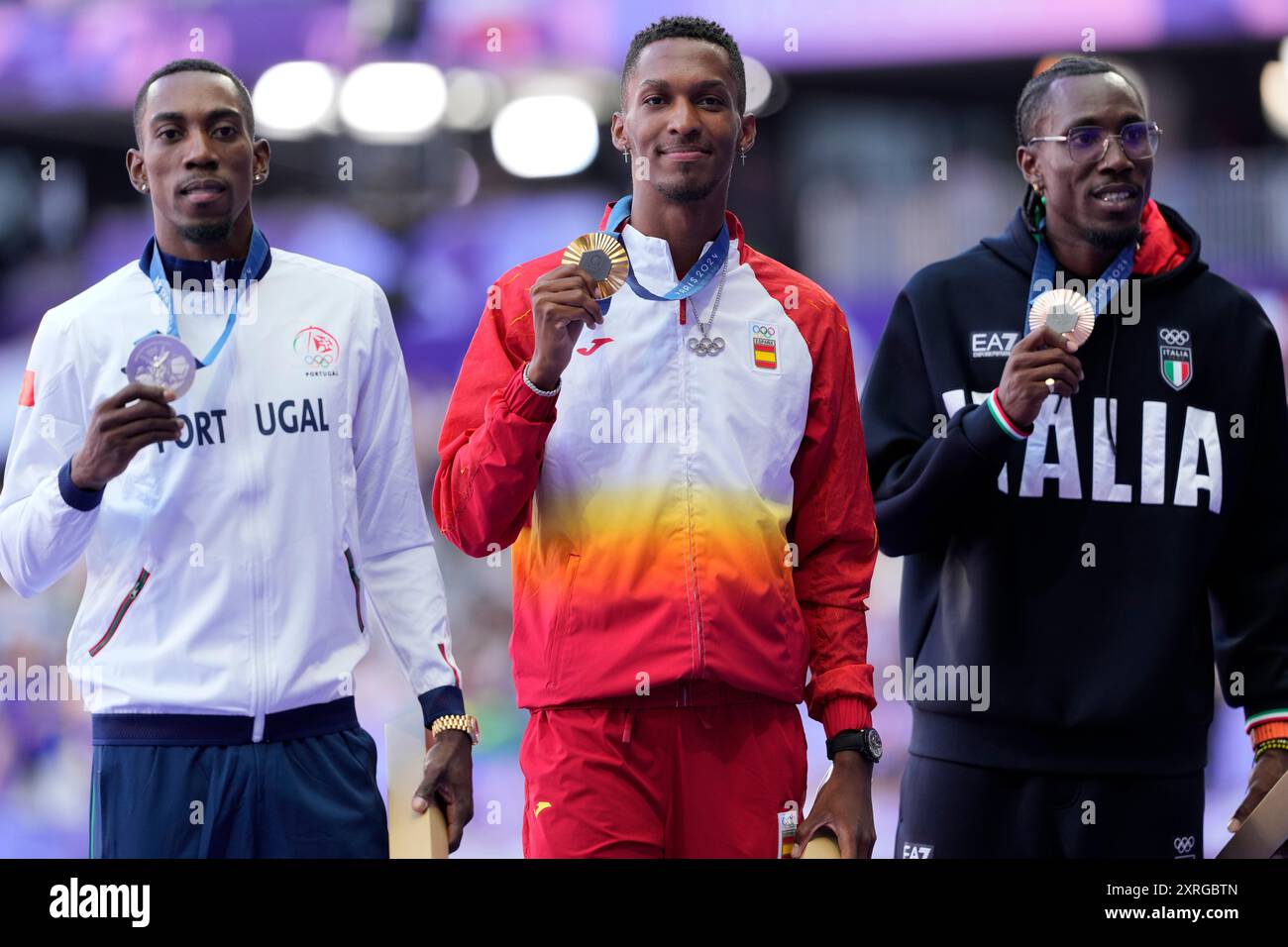 Men's triple jump gold medalist, Jordan Alejandro Diaz Fortun, centre, of Spain, stands with ...