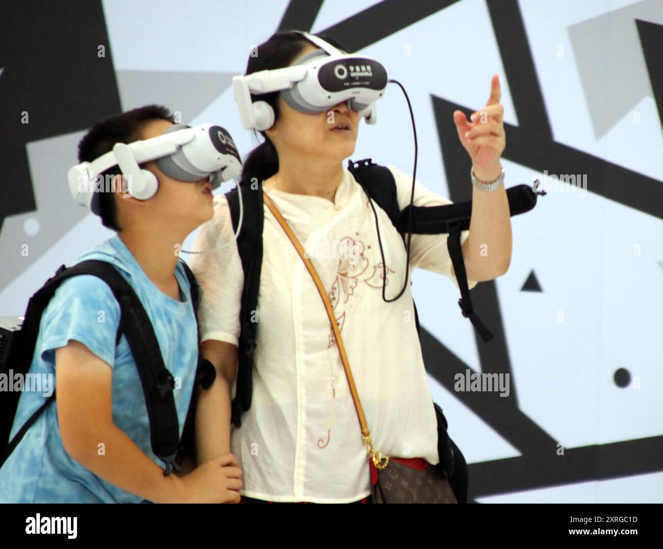 Suzhou, China. 10th Aug, 2024. Parents are taking their children to ...