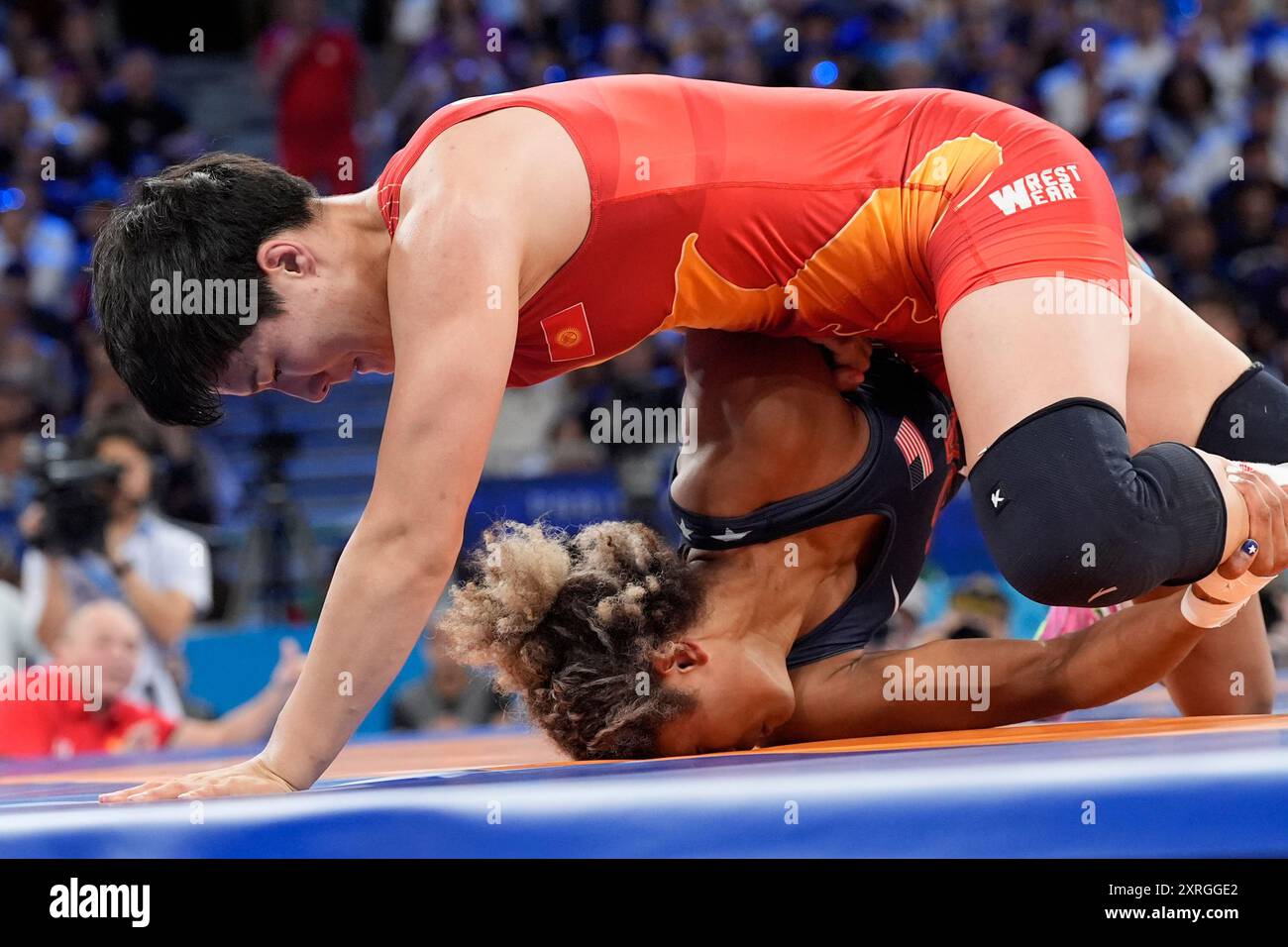 Kyrgyzstan's Aiperi Medet Kyzy, in red, and Kennedy Alexis Blades, of ...