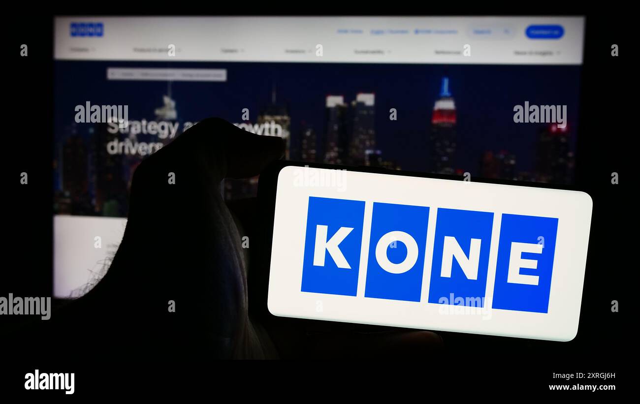 Person holding smartphone with logo of Finnish elevator engineering ...