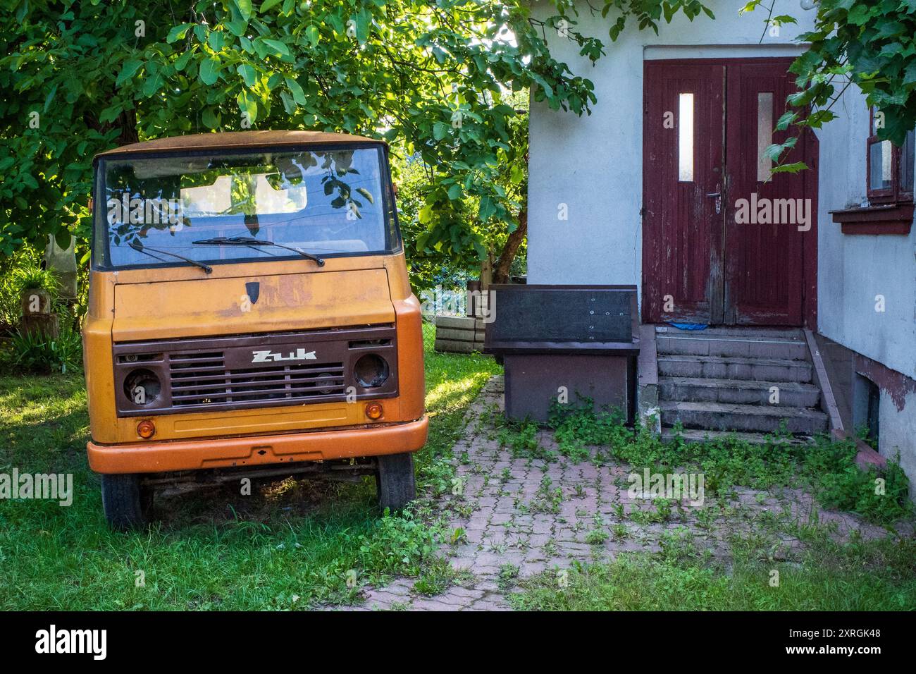 Vintage Eastern European truck rusting away outside an abandoned house ...