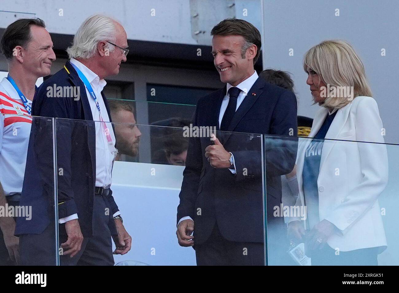 French President Emmanuel Macron, accompanied by wife Brigitte, flashes ...