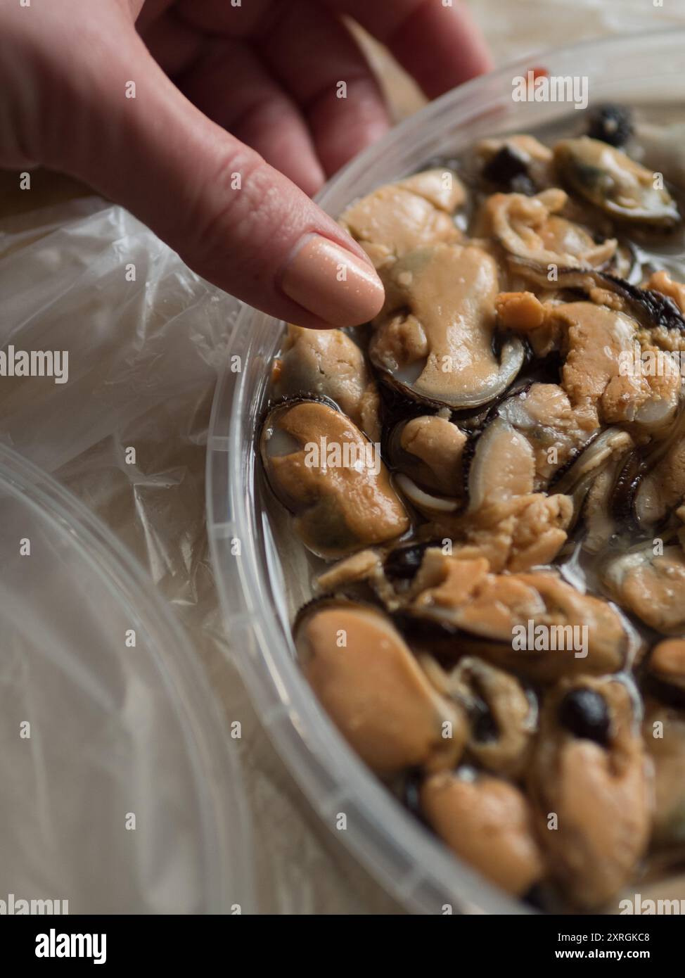 Vertical Close Up shot of a Woman’s Hand Touching a Plastic Containers ...