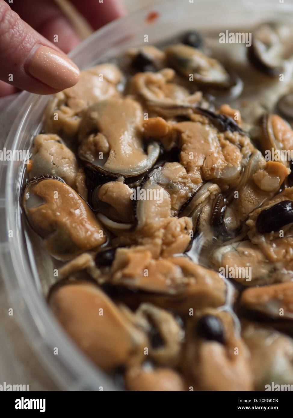 Vertical Close Up shot of a Woman’s Hand Touching a Plastic Containers ...