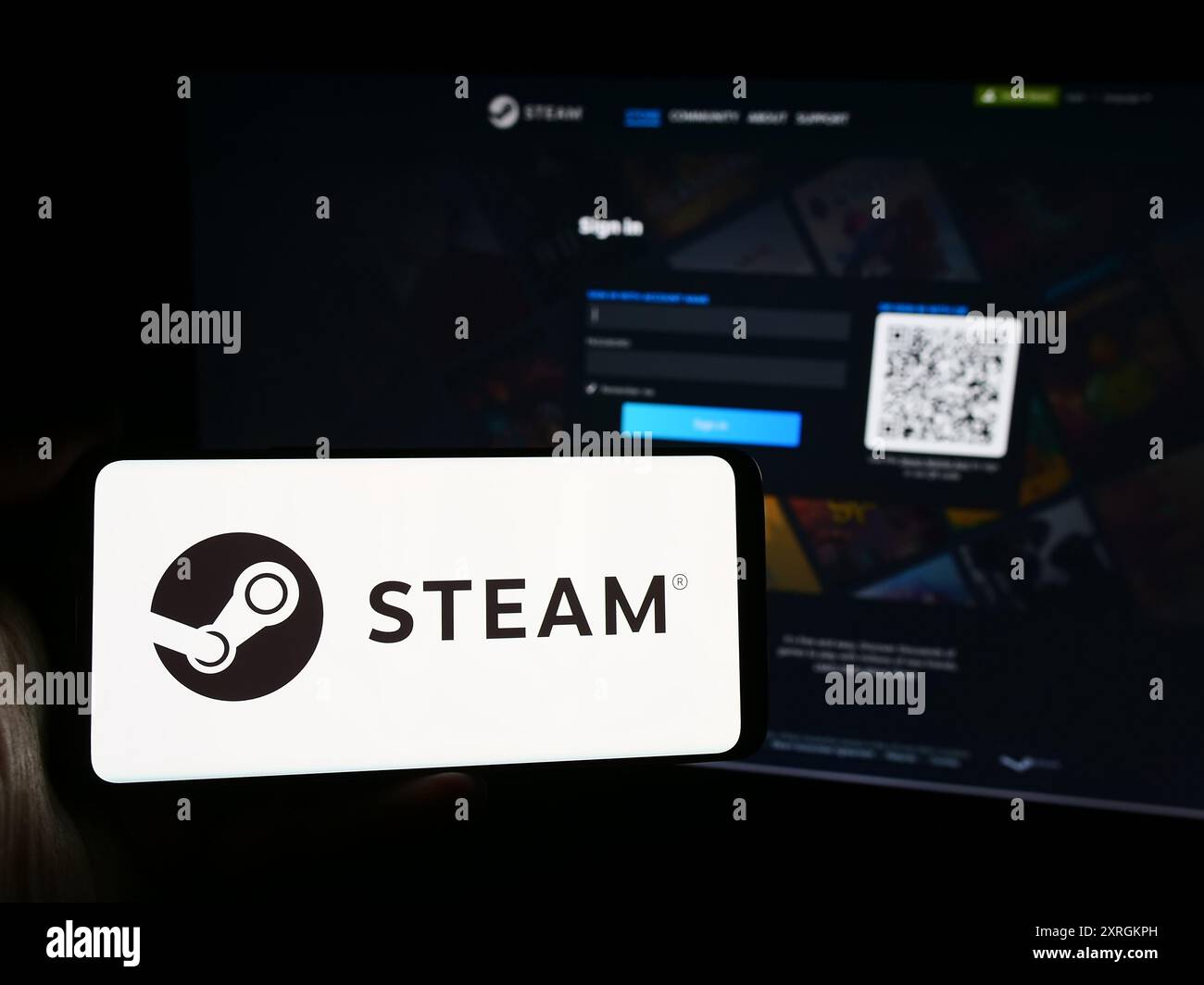 Person holding smartphone with logo of US video game distribution ...