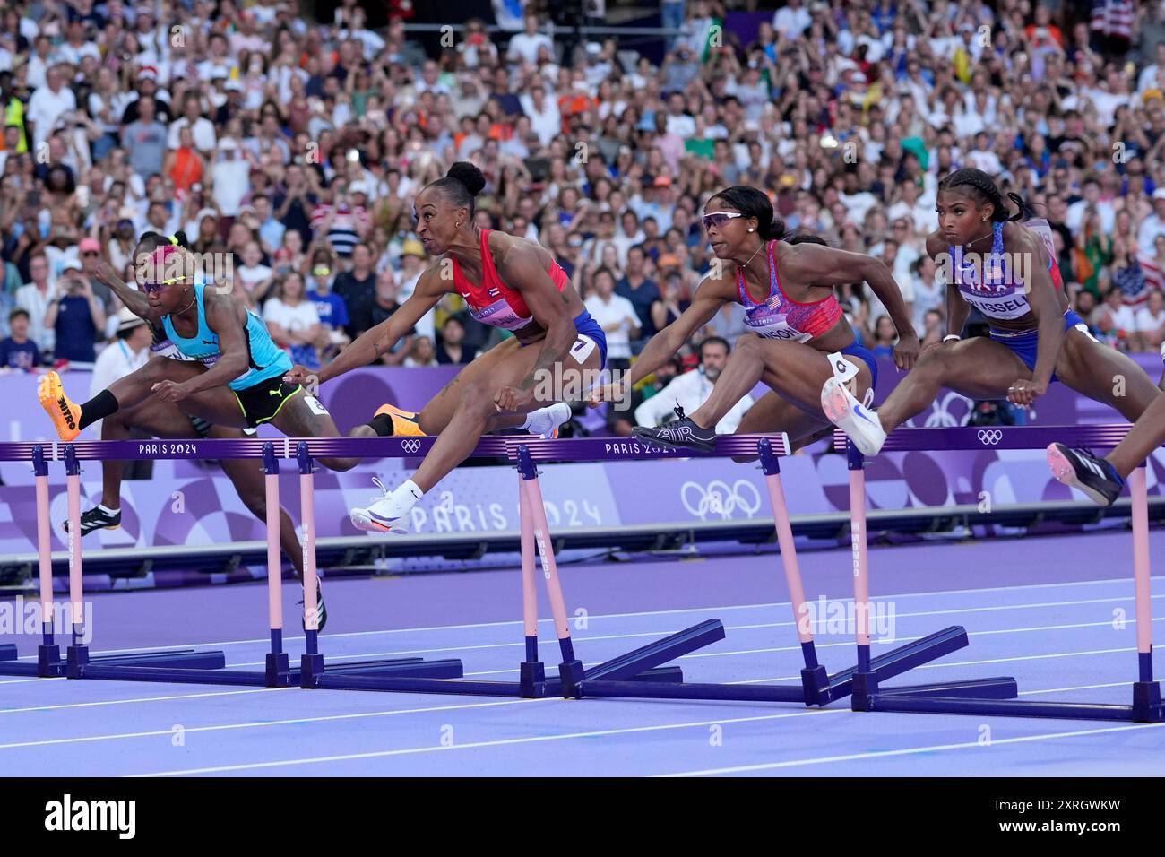 Competitors race in the women's 100-meter hurdles final at the 2024 ...