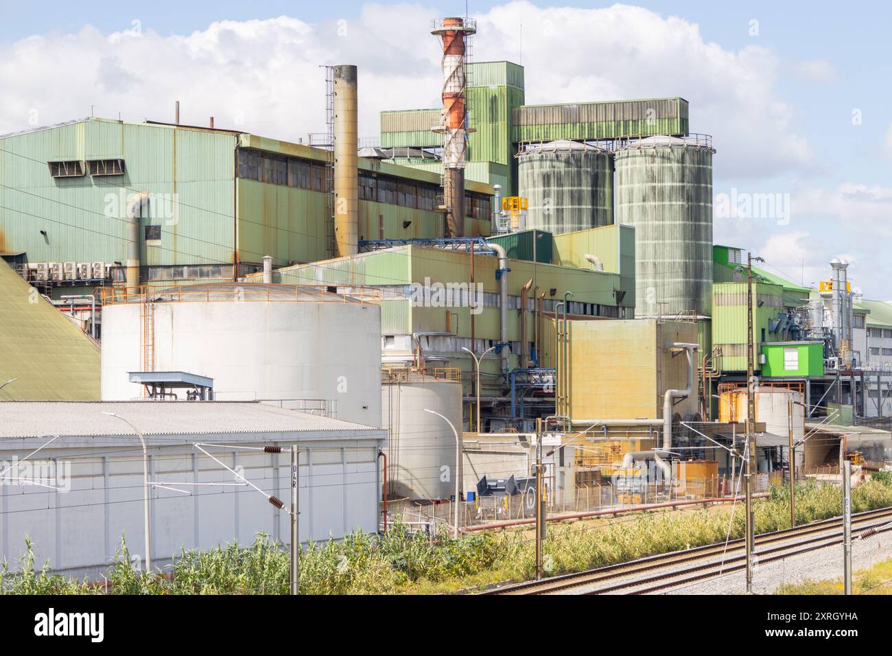 Industrial exterior of a sugar refinery processing plant with machinery ...