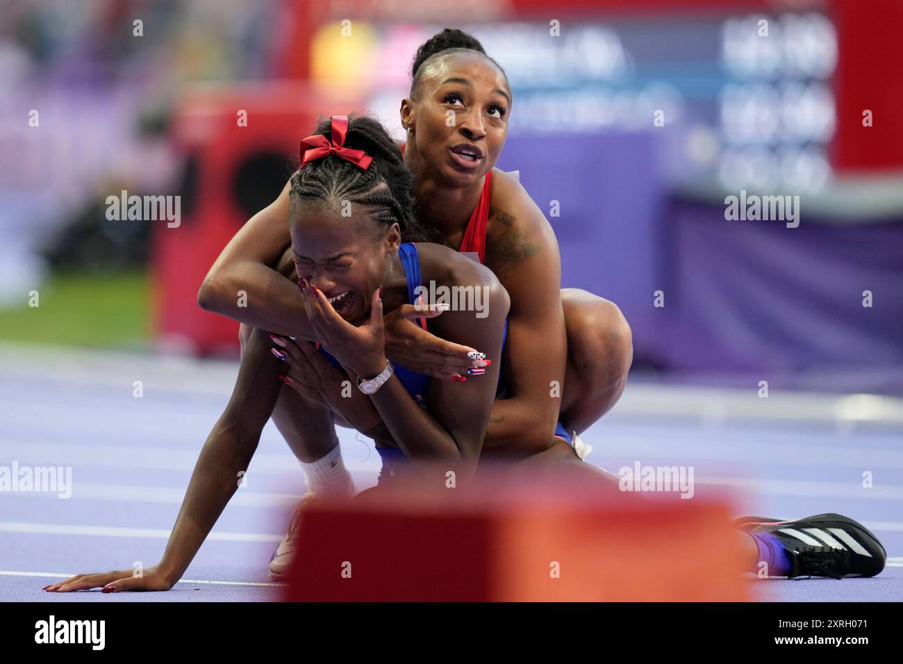 Bronze medalist Jasmine Camacho-Quinn, of Puerto Rico, embraces Cyréna ...