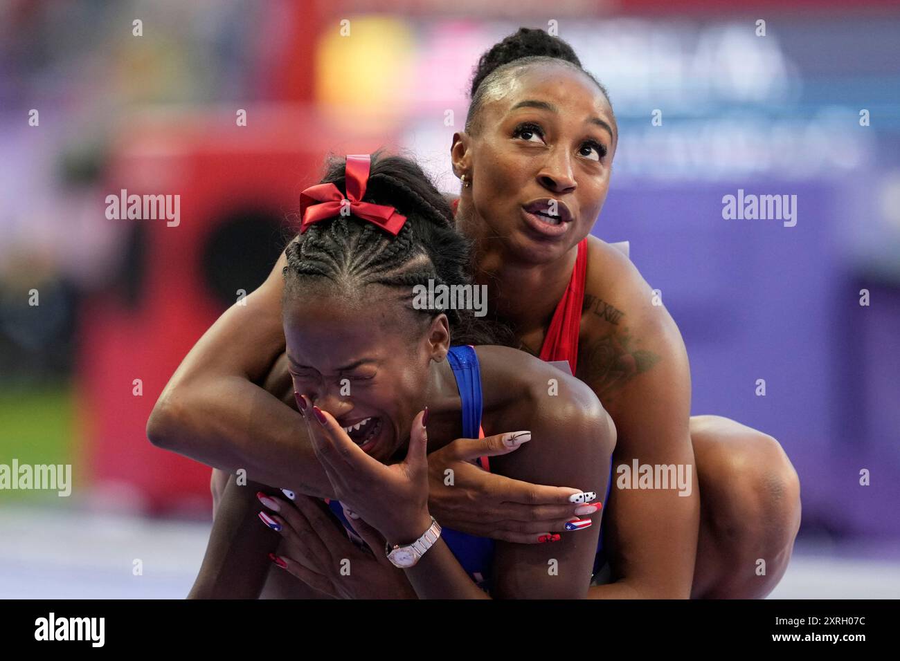 Bronze medalist Jasmine Camacho-Quinn, of Puerto Rico, embraces Cyréna ...