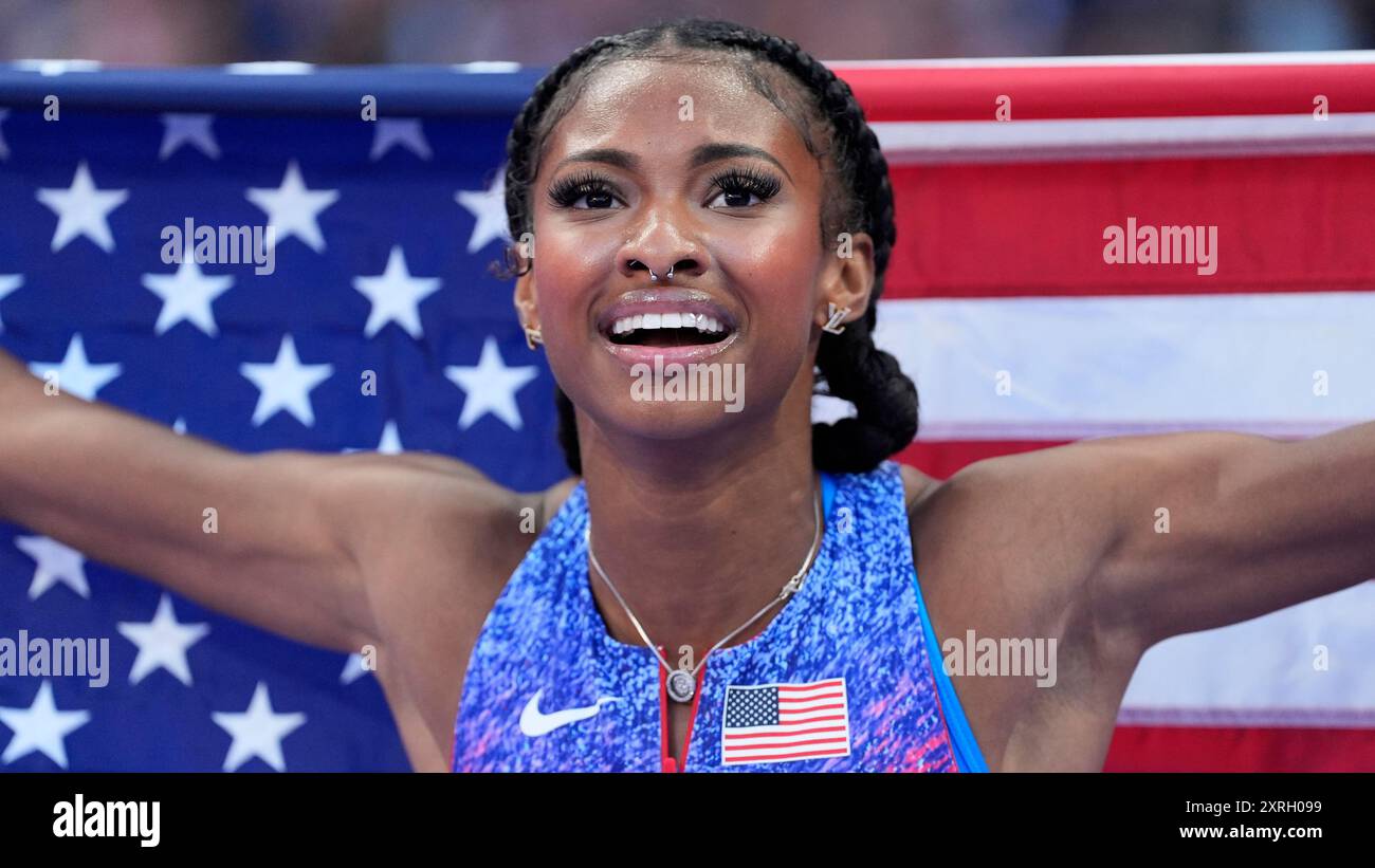 Masai Russell, of the United States, celebrates winning the women's 100 ...