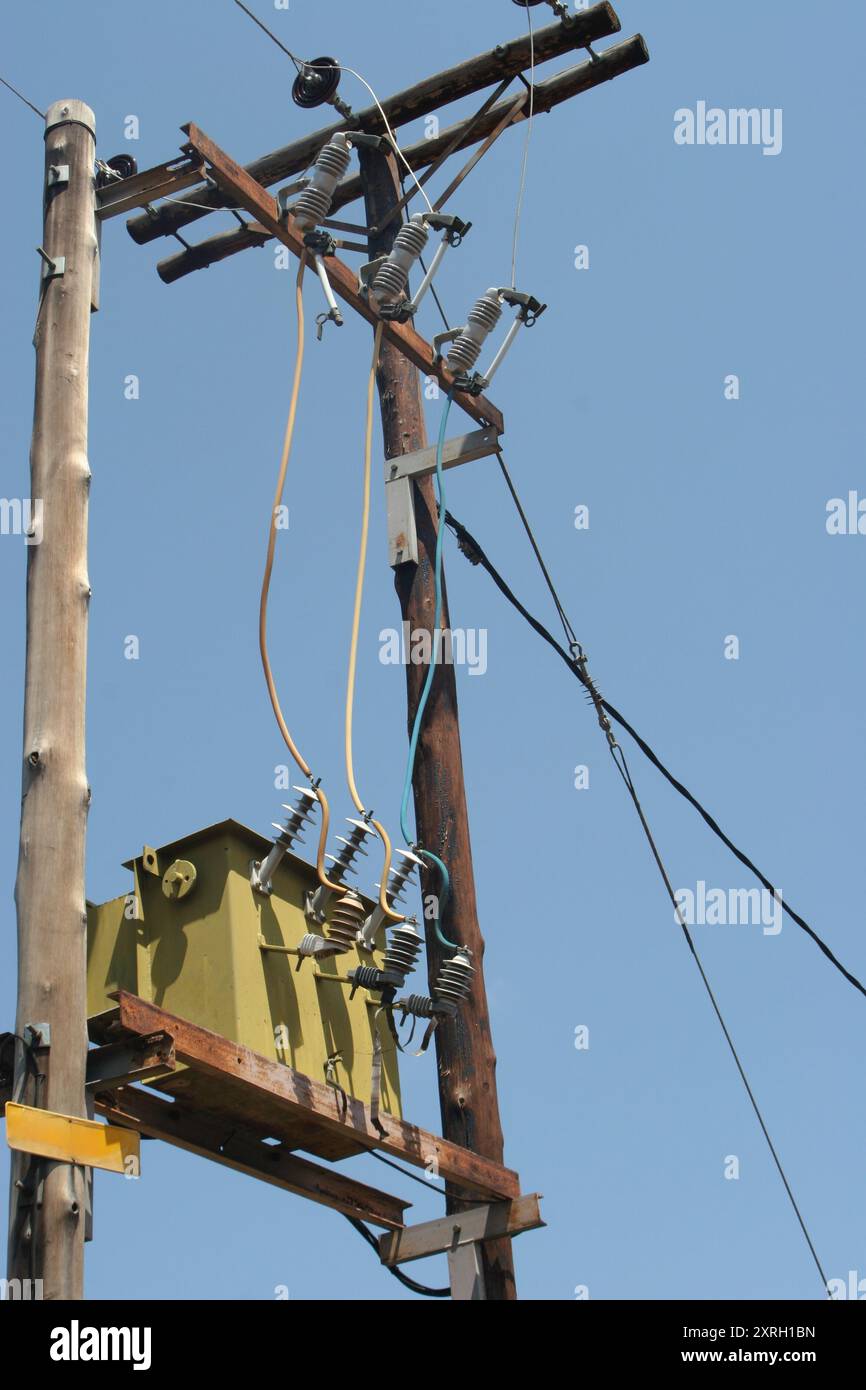 electricity transformer on wooden poles, old style electric ...