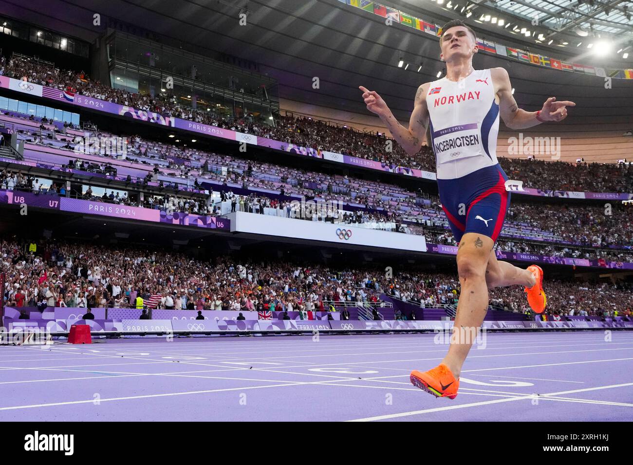 Jakob Ingebrigtsen, of Norway, celebrates after winning the men's 5000 ...