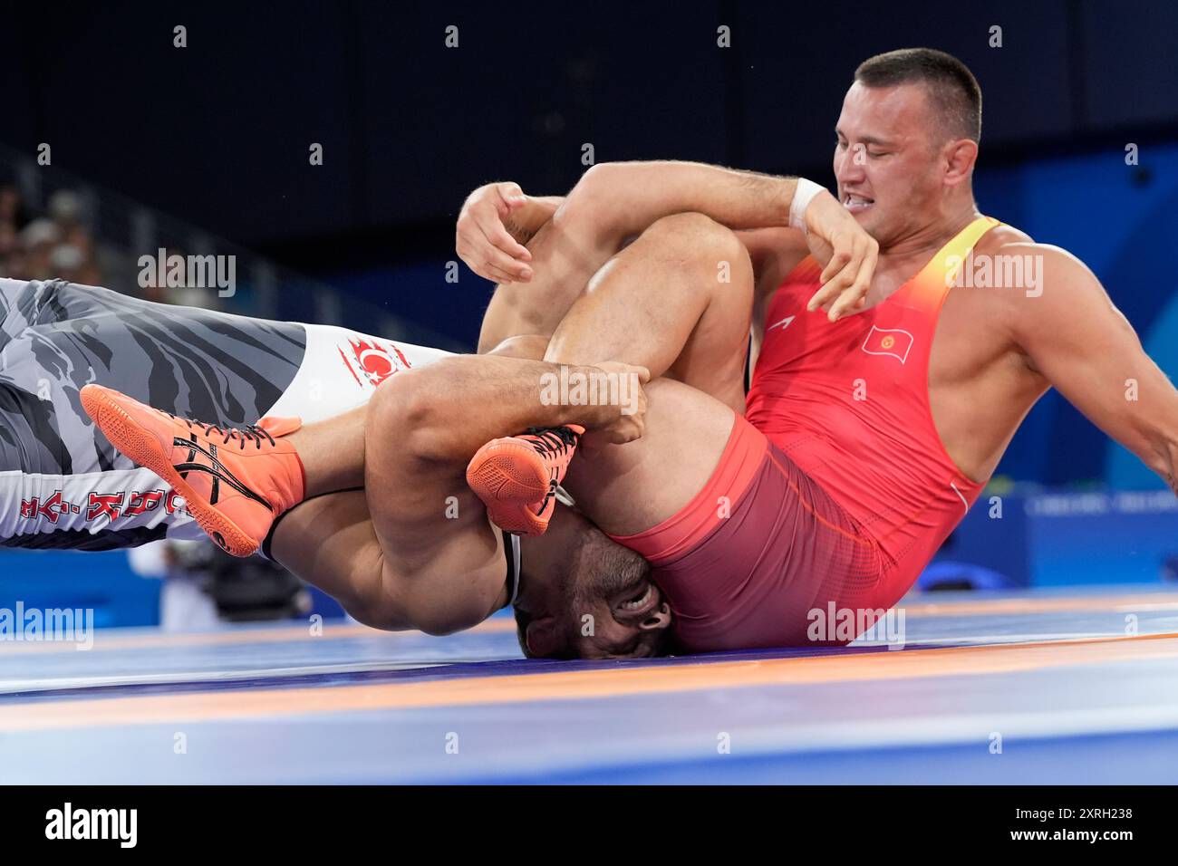 Kyrgyzstan's Aiaal Lazarev, in red, and Turkey's Taha Akgul compete in their men's freestyle ...