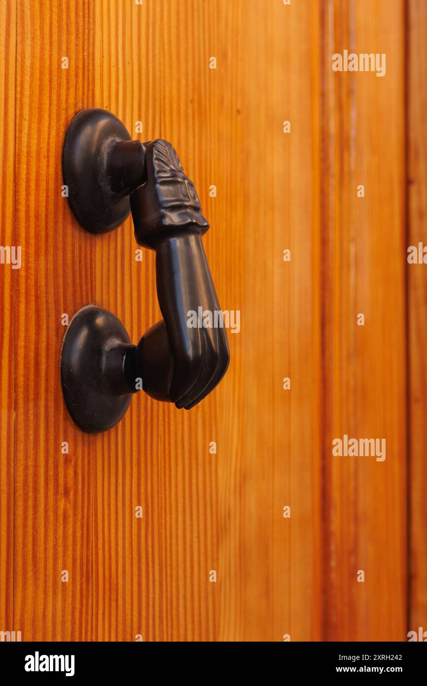 Antique knocker, door handle or knocker on a wooden door, Bocairent ...