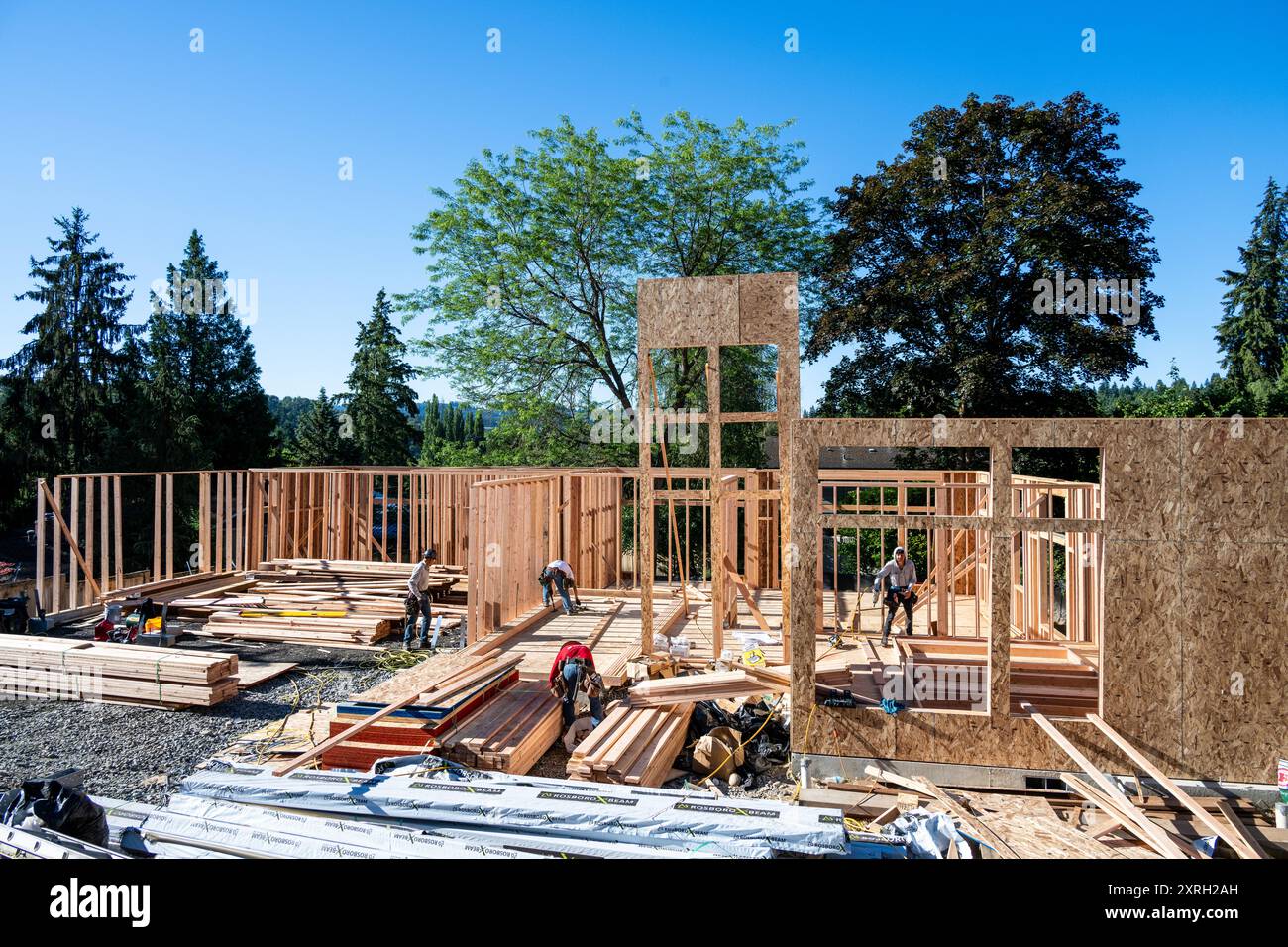 BELLEVUE, WA – JUN 26, 2024: construction crew hard at work framing new ...