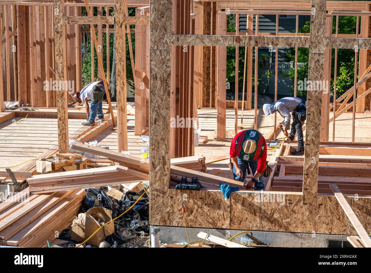 BELLEVUE, WA – JUN 26, 2024: construction crew hard at work framing new ...