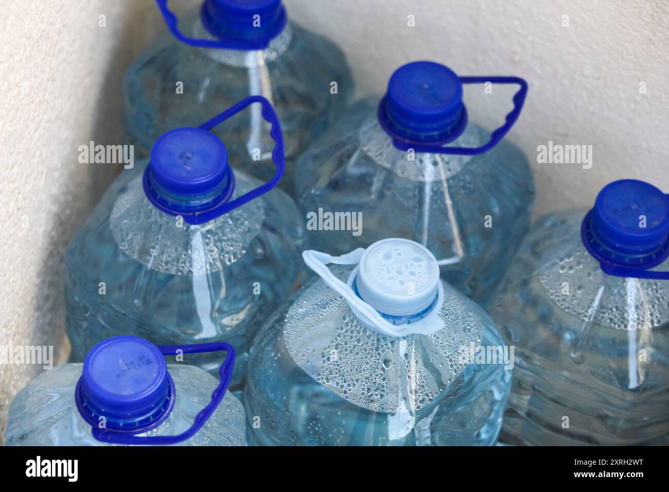 An overhead view of large plastic bottles of purified drinking water. A ...