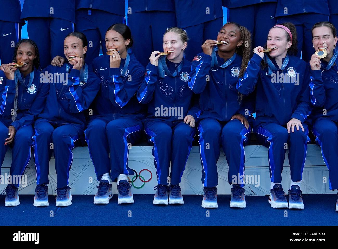 United States soccer team players bite their gold medals after the ...