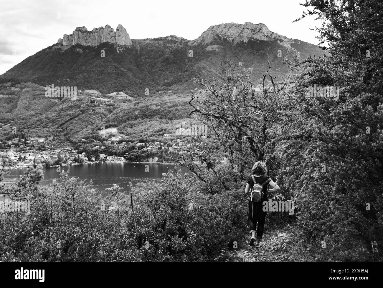 Young woman hiking over beautiful Annecy lake, known as Europe's ...