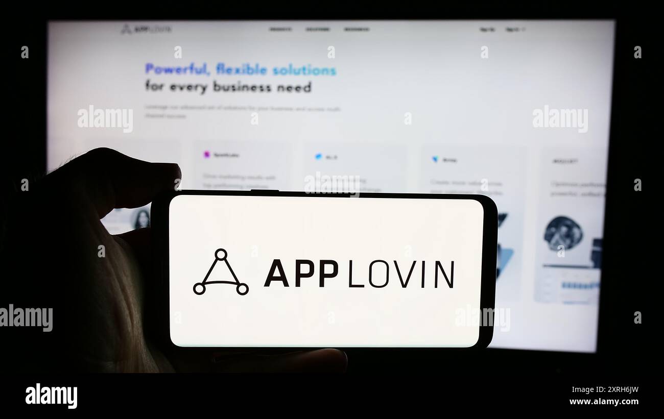 Person holding cellphone with logo of American mobile technology ...