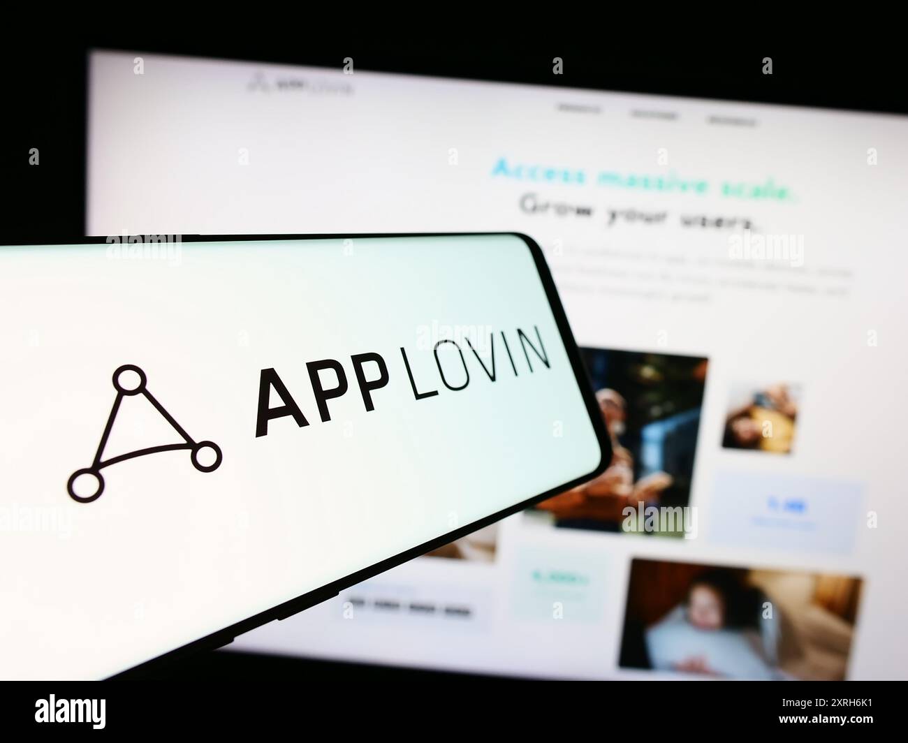 Smartphone with logo of American mobile technology company AppLovin Corporation in front of ...