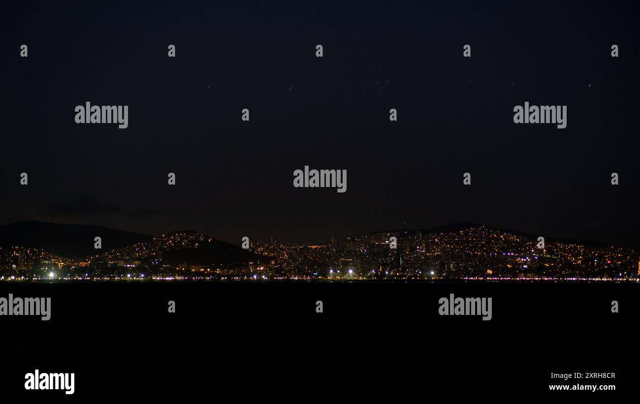 The city of Istanbul glows under the night sky, showcasing vibrant ...