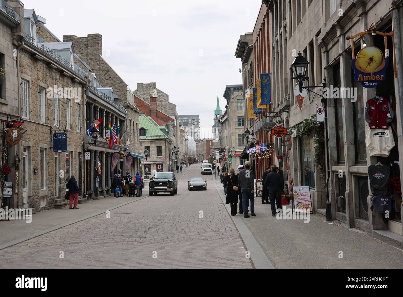 Montreal in autumn #2. A bustling cobblestone street is lined with ...