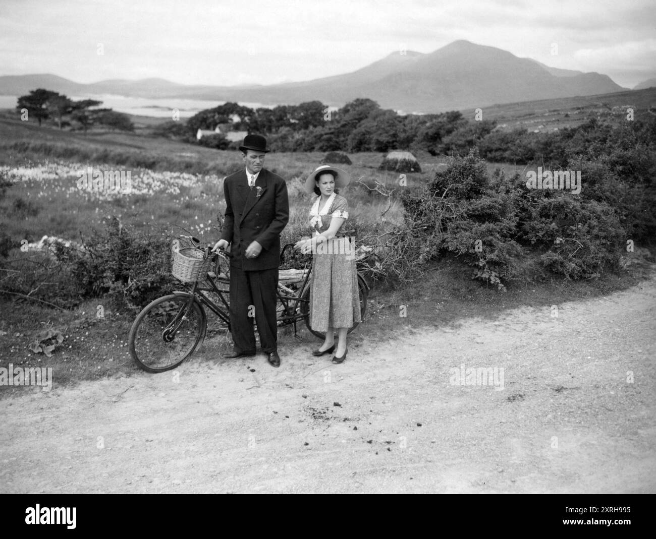 JOHN WAYNE and MAUREEN O'HARA relax between scenes filming in Ireland ...
