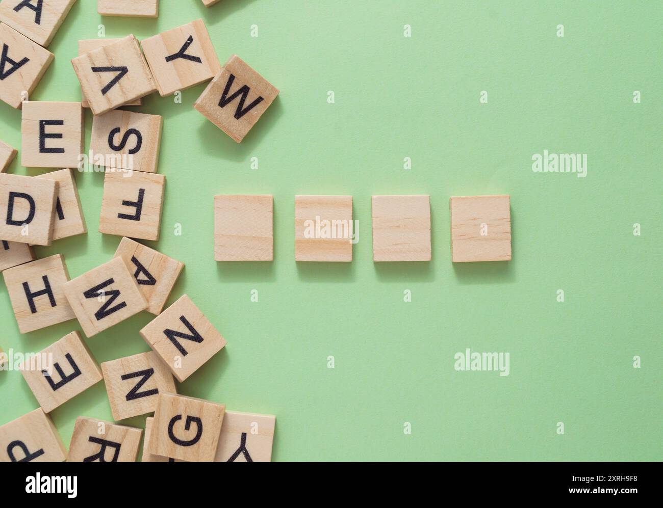 A pile of wooden letters. The letters are scattered across the image ...