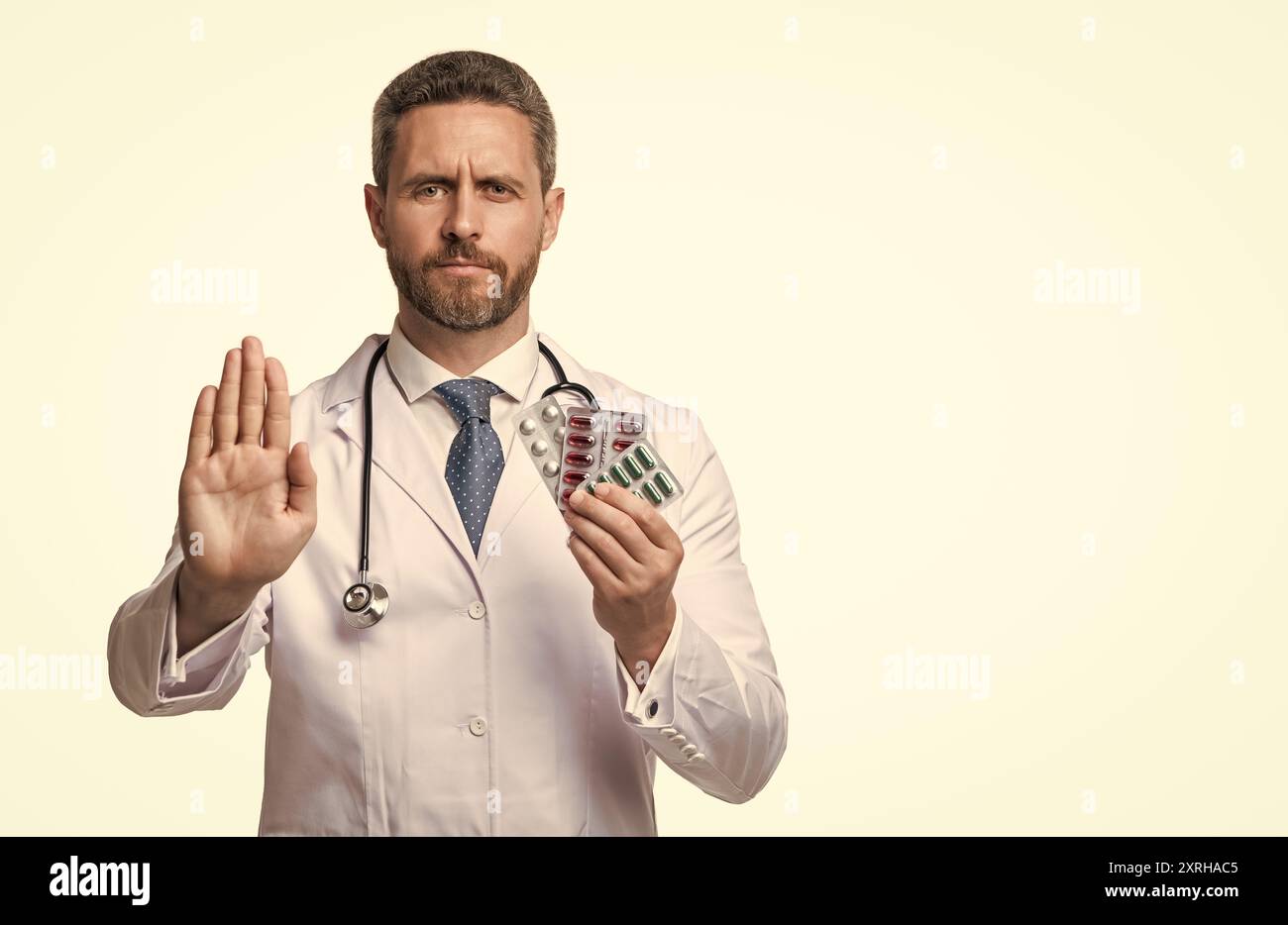 stop the pills. doctor hold pill with stop gesture. stop taking ...