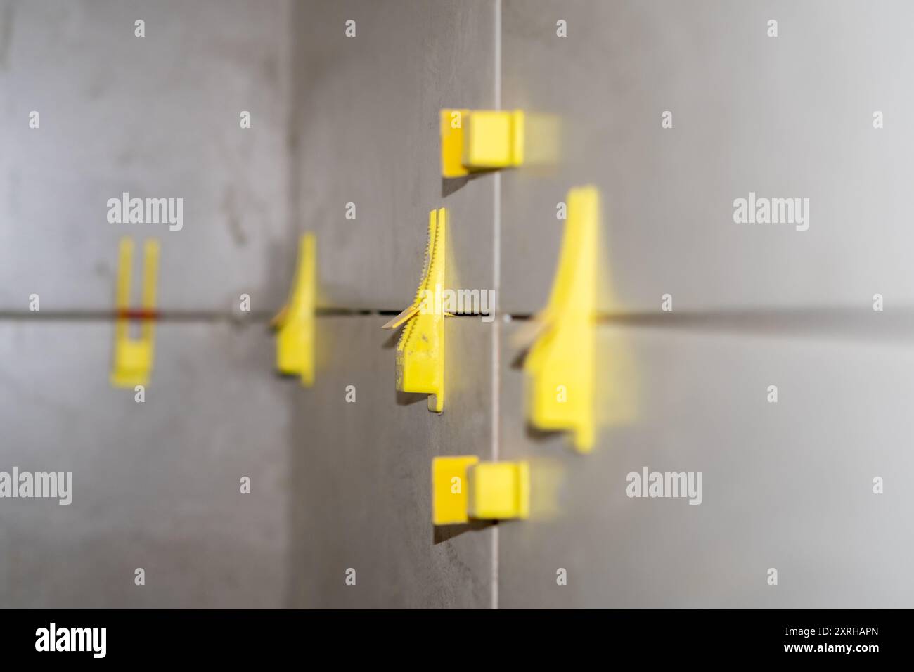 Tile installation using plastic leveling clips and wedges. Ensuring a ...