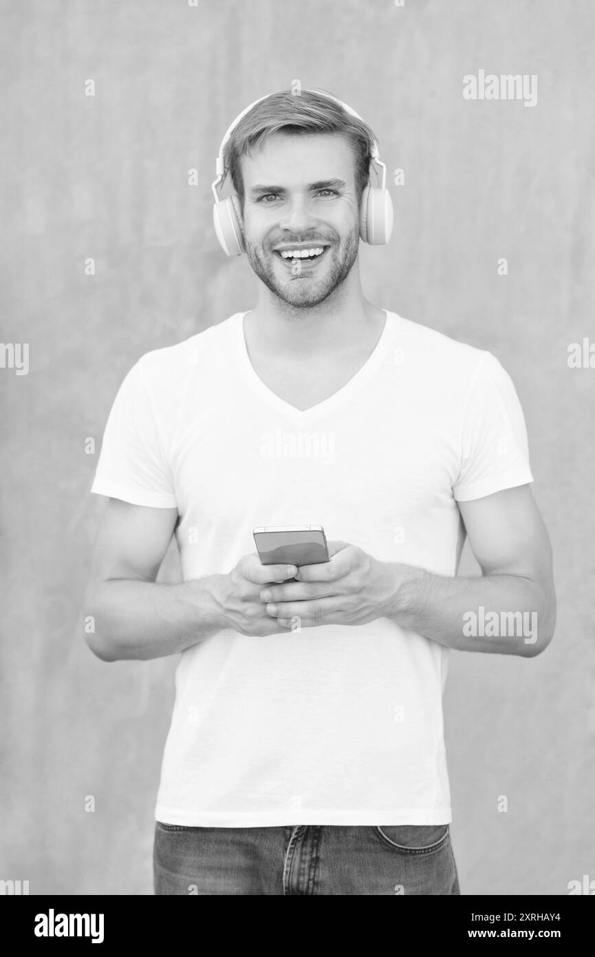 photo of glad man mp3 music playlist in headphones. man open mp3 music ...