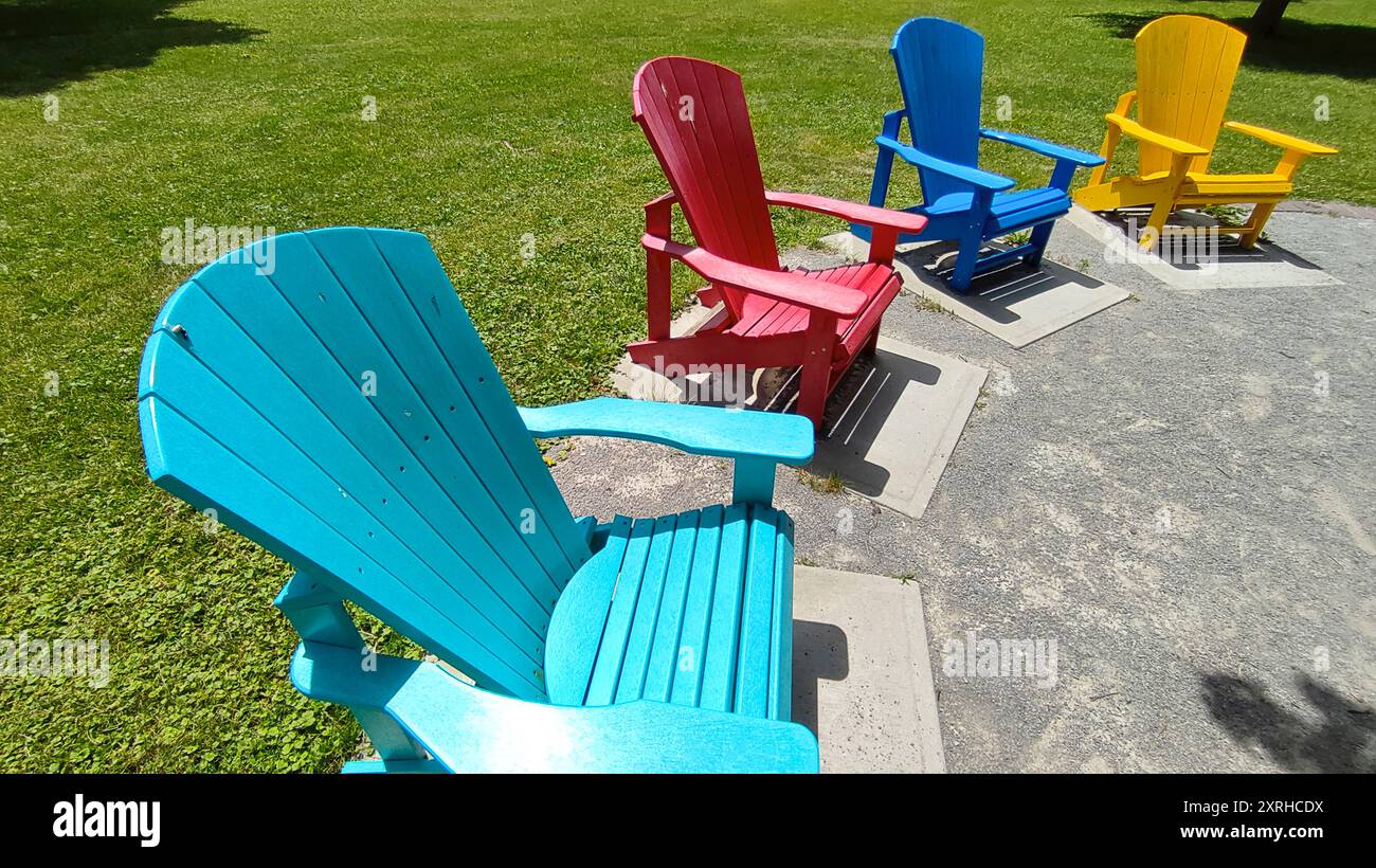 Colourful Adirondack Chairs in the public park Stock Photo - Alamy