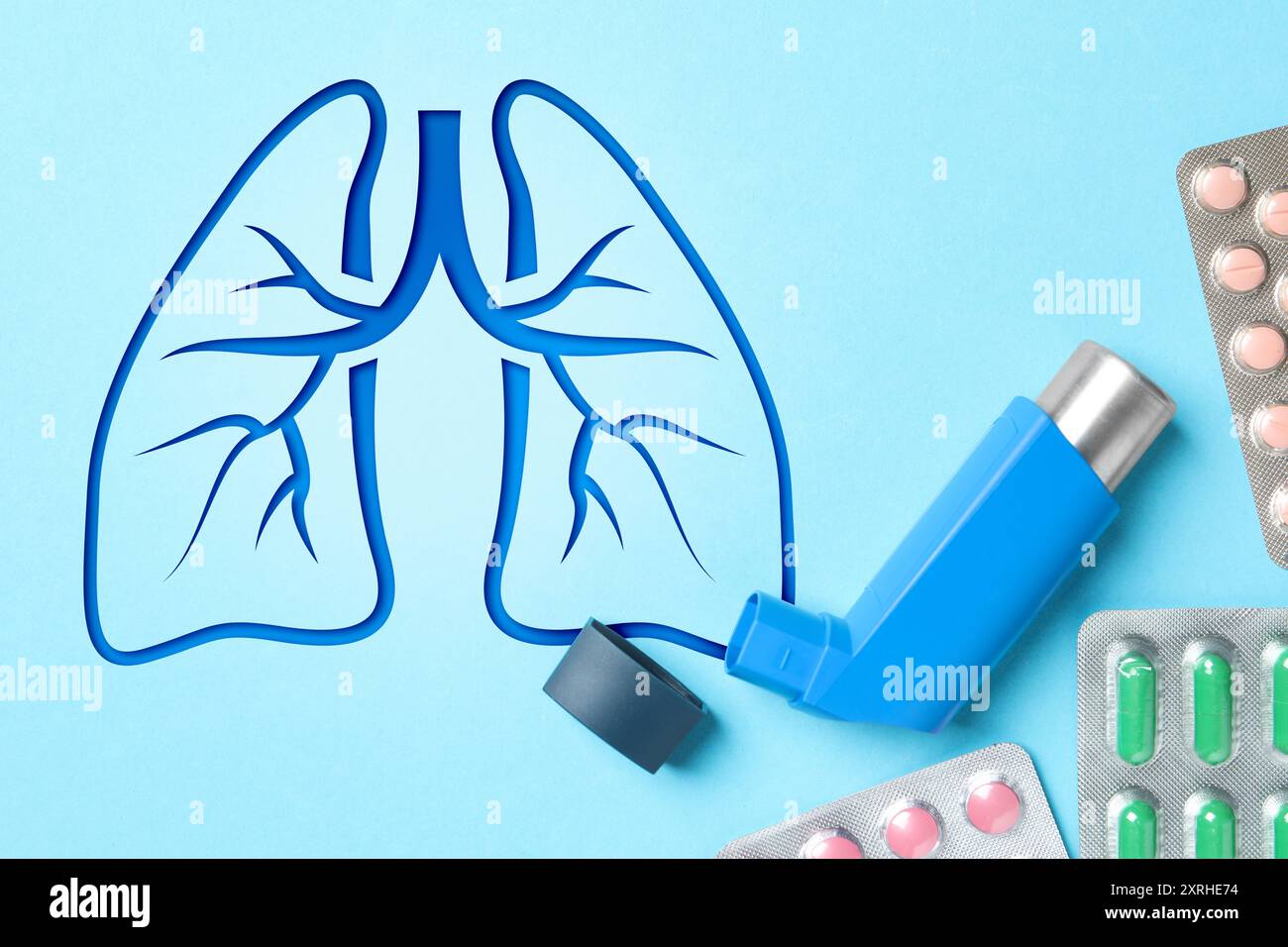 Asthma inhaler, drugs and illustration of lungs on light blue ...
