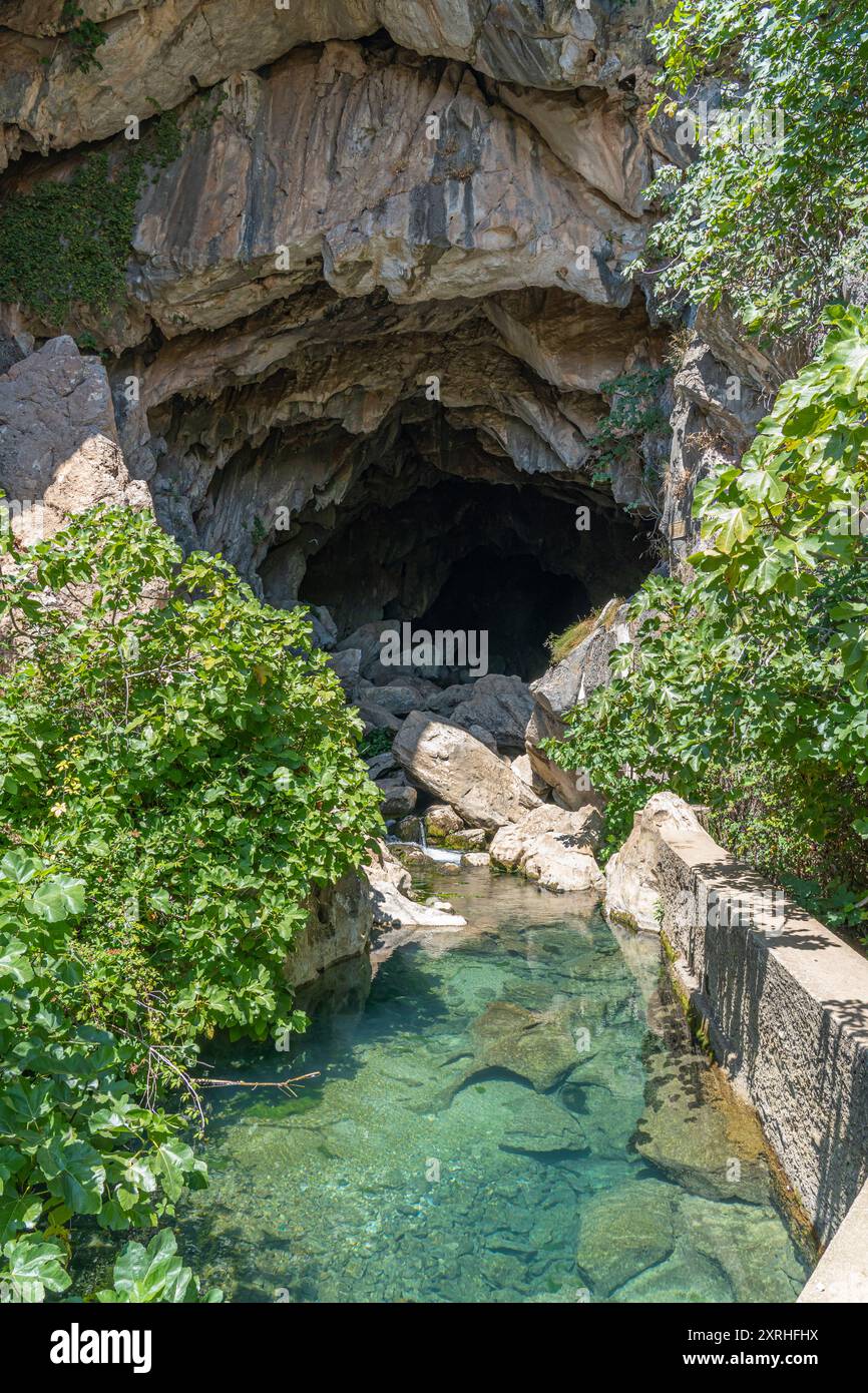 The rugged entrance of Cueva del Gato, a stunning limestone cave near ...