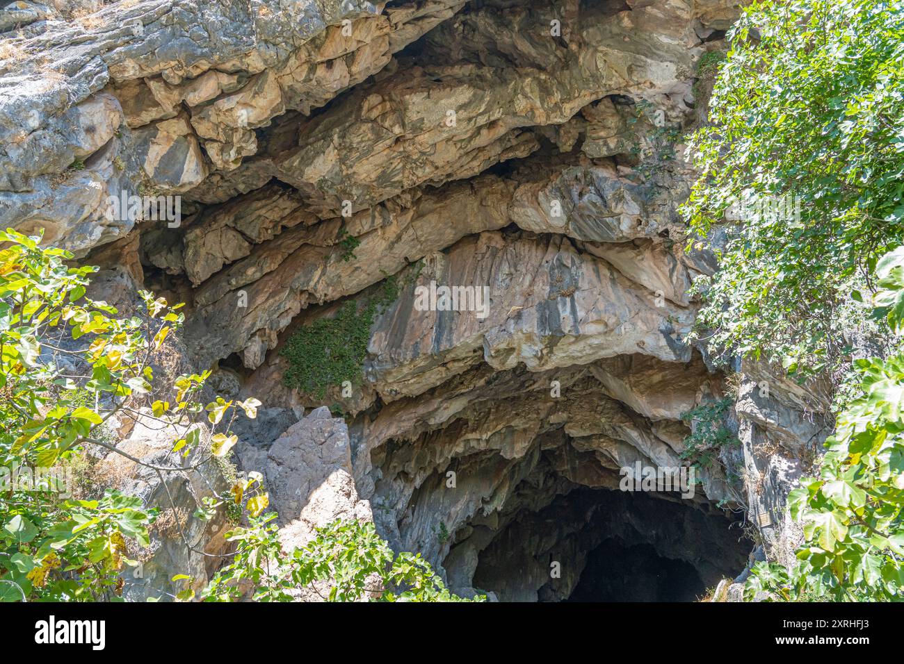 The rugged entrance of Cueva del Gato, a stunning limestone cave near ...