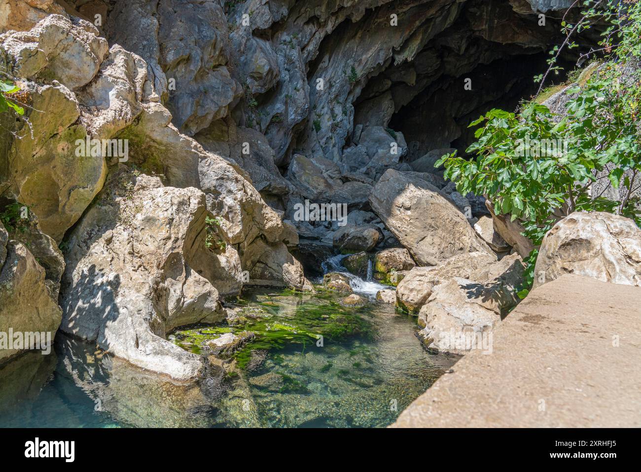 The rugged entrance of Cueva del Gato, a stunning limestone cave near ...
