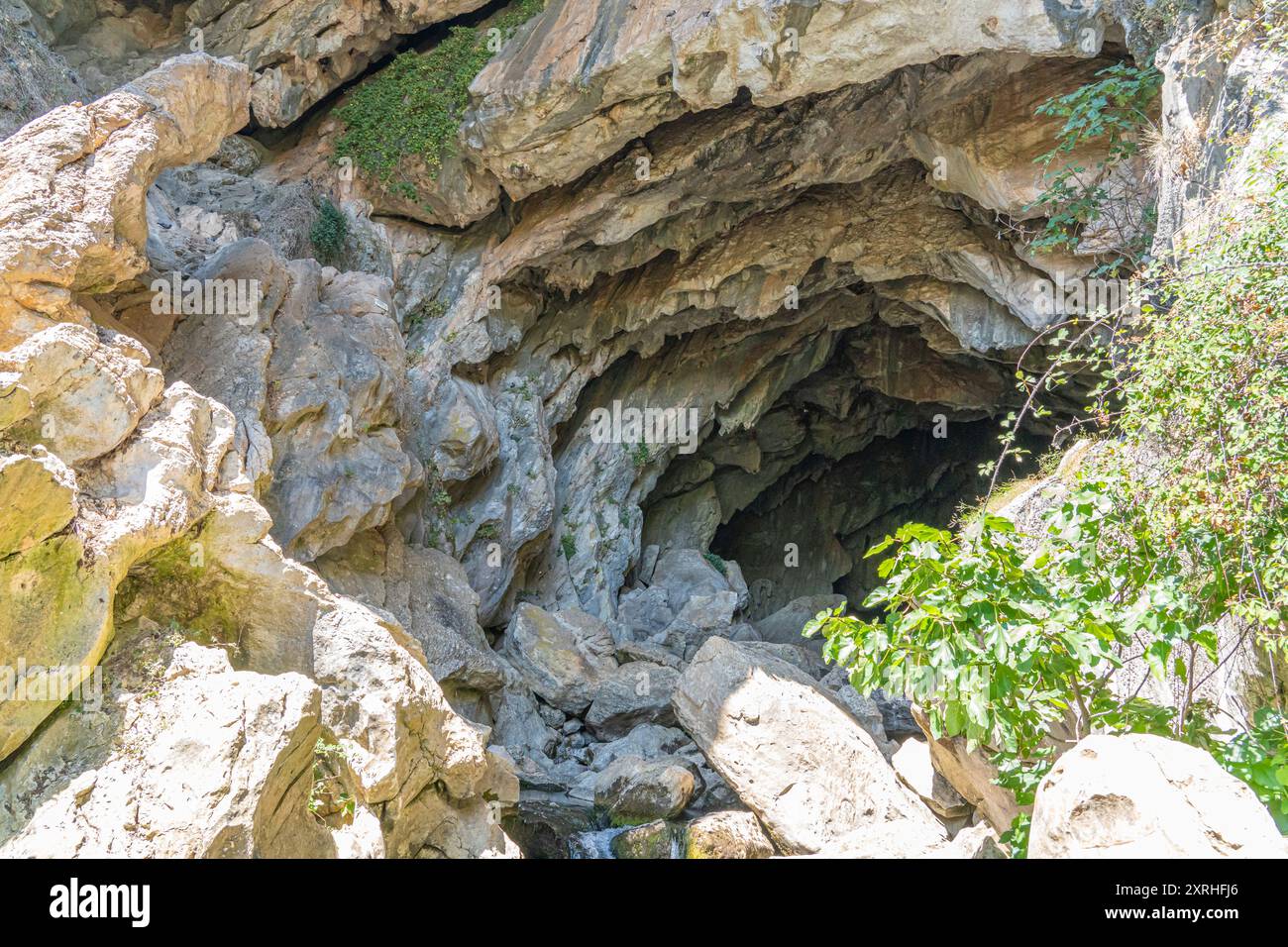 The rugged entrance of Cueva del Gato, a stunning limestone cave near ...