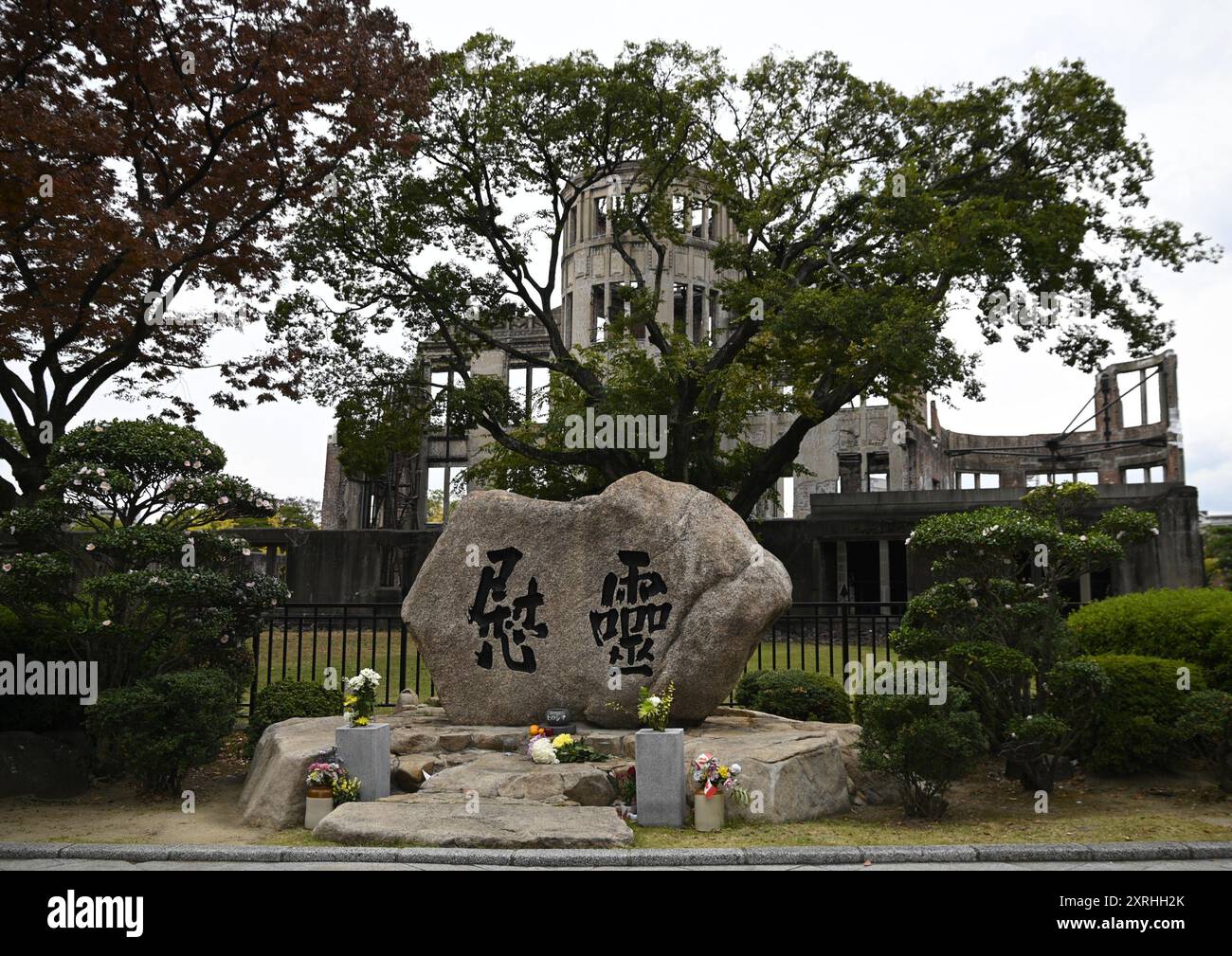 Scenic view of a stone memorial landmark on the foreground of Genbaku ...