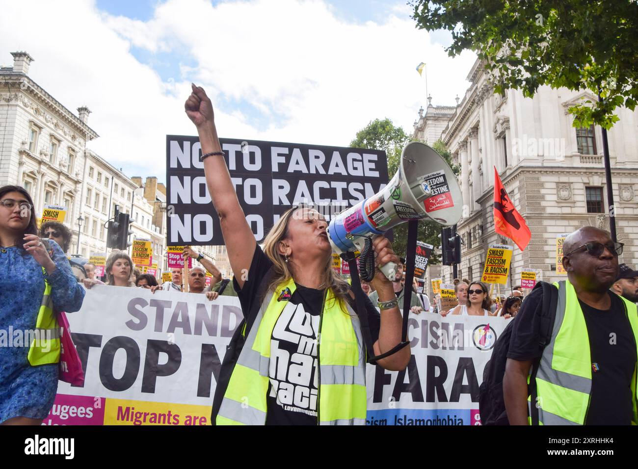 London, UK. 10th Aug, 2024. A protester chants slogans through a ...