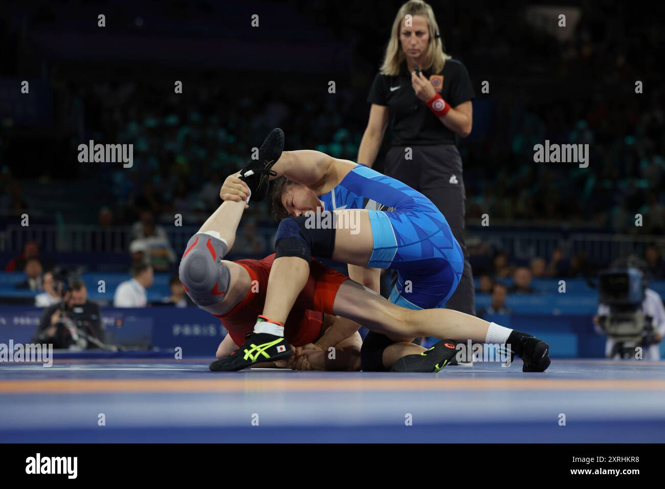 Japan's MOTOKI Sakura (blue) fights against KOLIADENKO Iryna (red) of ...