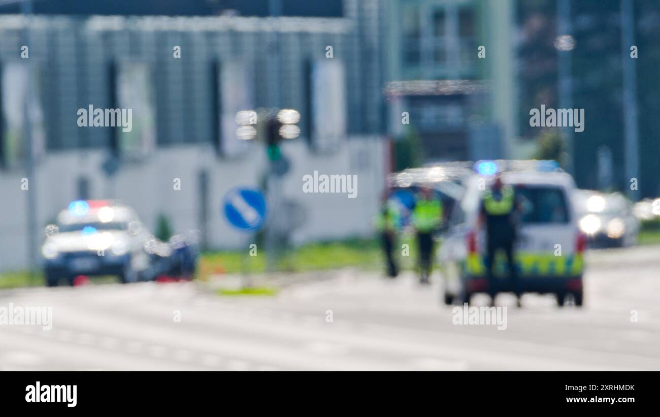 Two police cars and police officers in action. Blurred police scene ...