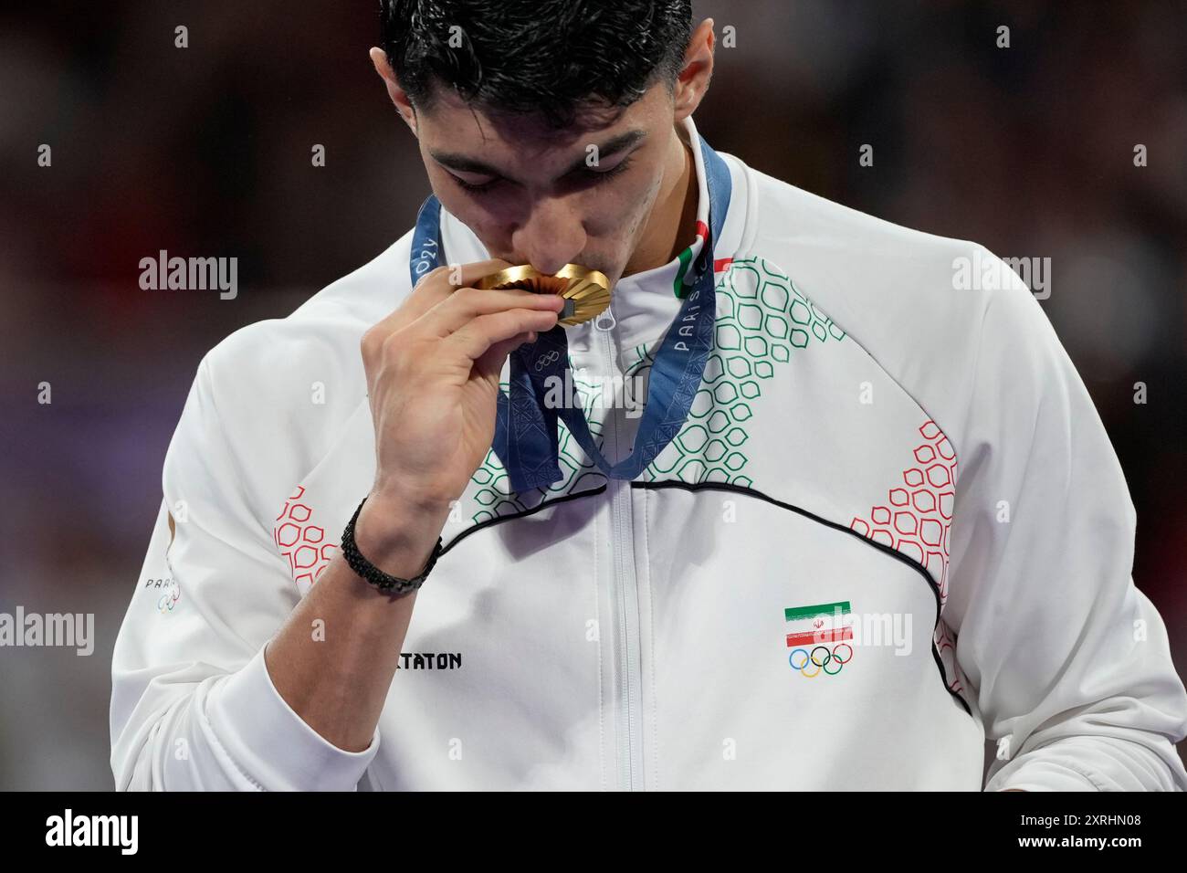 Iran's Arian Salimi celebrates on the podium after winning the gold ...