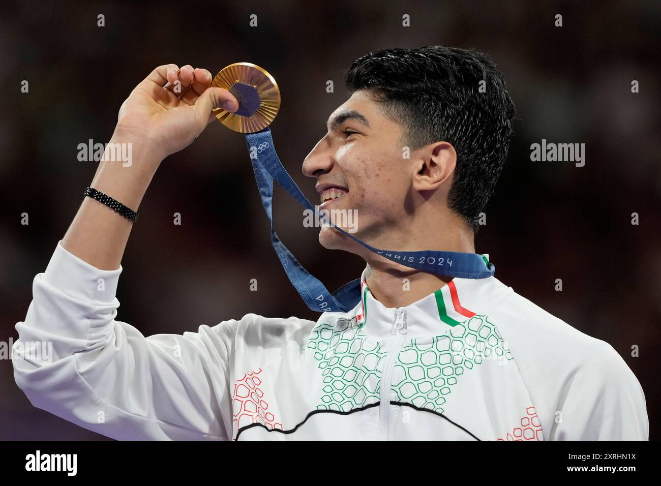 Iran's Arian Salimi celebrates on the podium after winning the gold ...