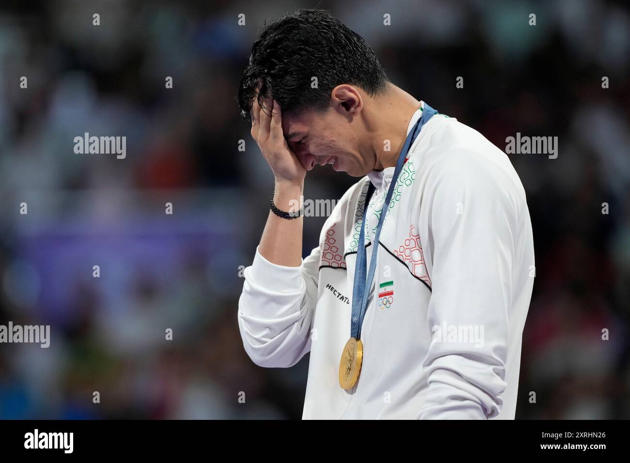 Iran's Arian Salimi celebrates on the podium after winning the gold ...