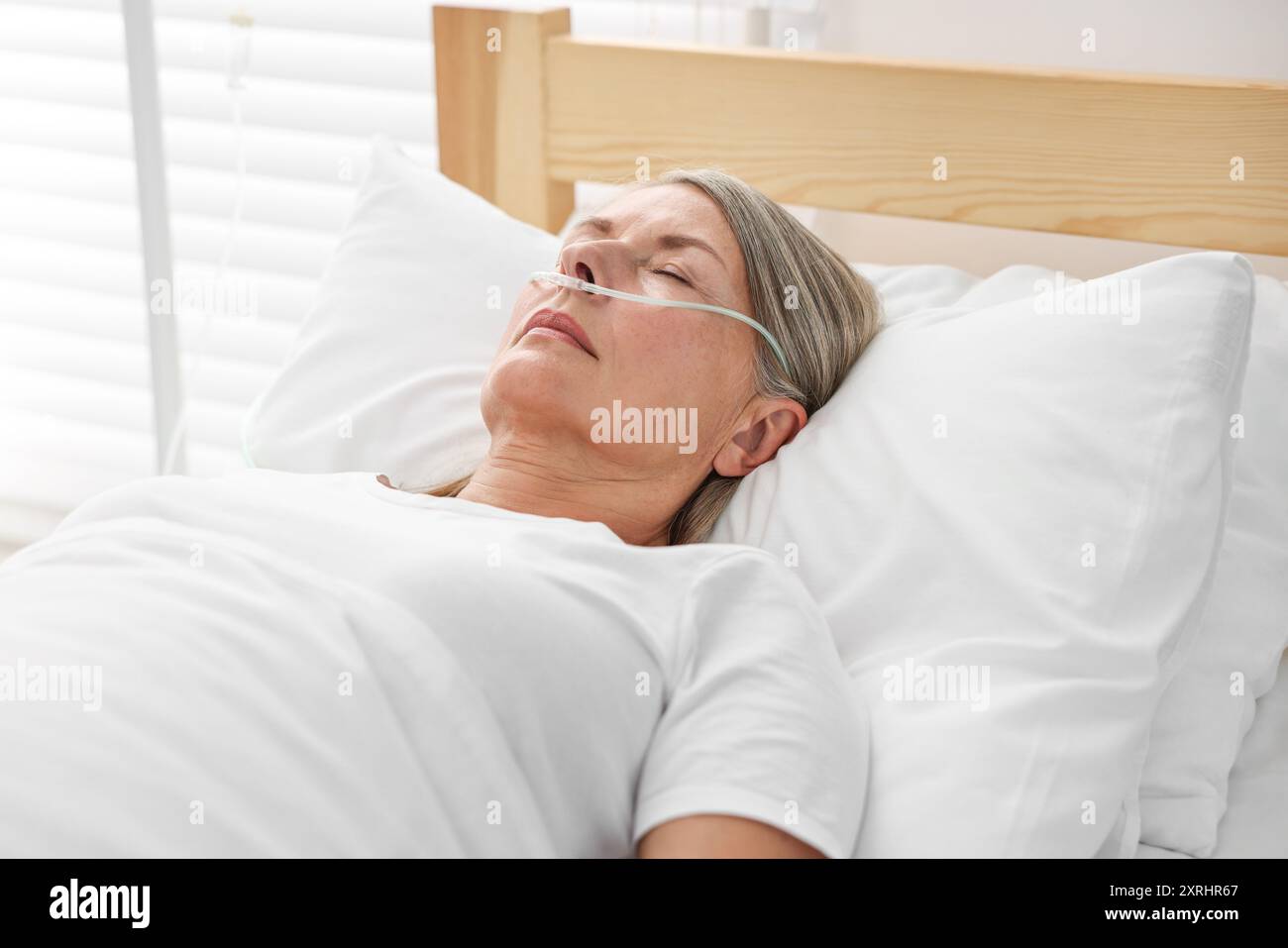 Coma patient. Mature woman sleeping in hospital bed Stock Photo - Alamy