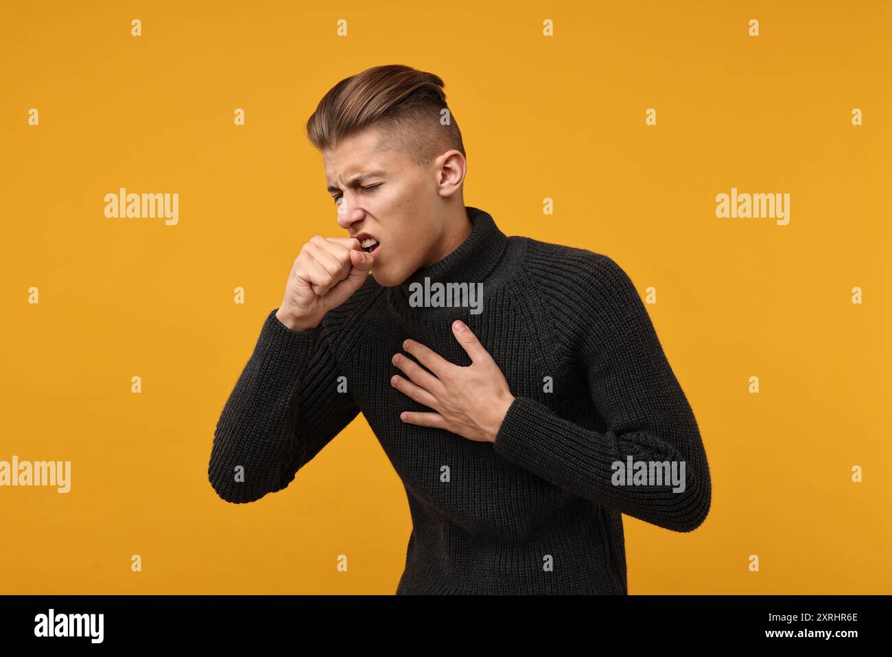 Sick man coughing on orange background. Cold symptoms Stock Photo - Alamy