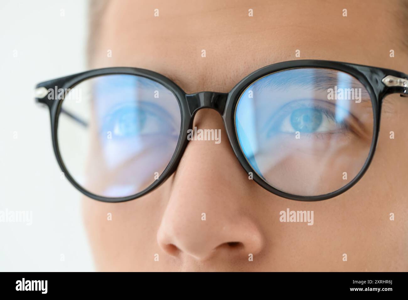 Vision correction. Man wearing glasses on blurred background, closeup ...