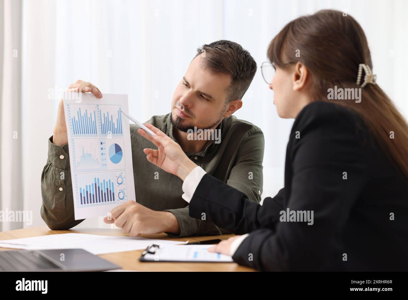 Consultant working with partner at table in office. Business meeting ...