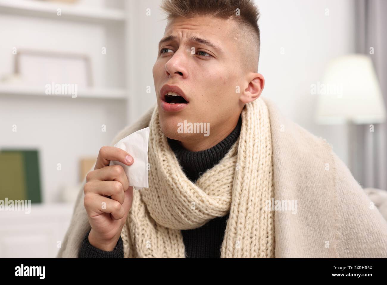 Cold symptom. Young man suffering from fever at home Stock Photo - Alamy